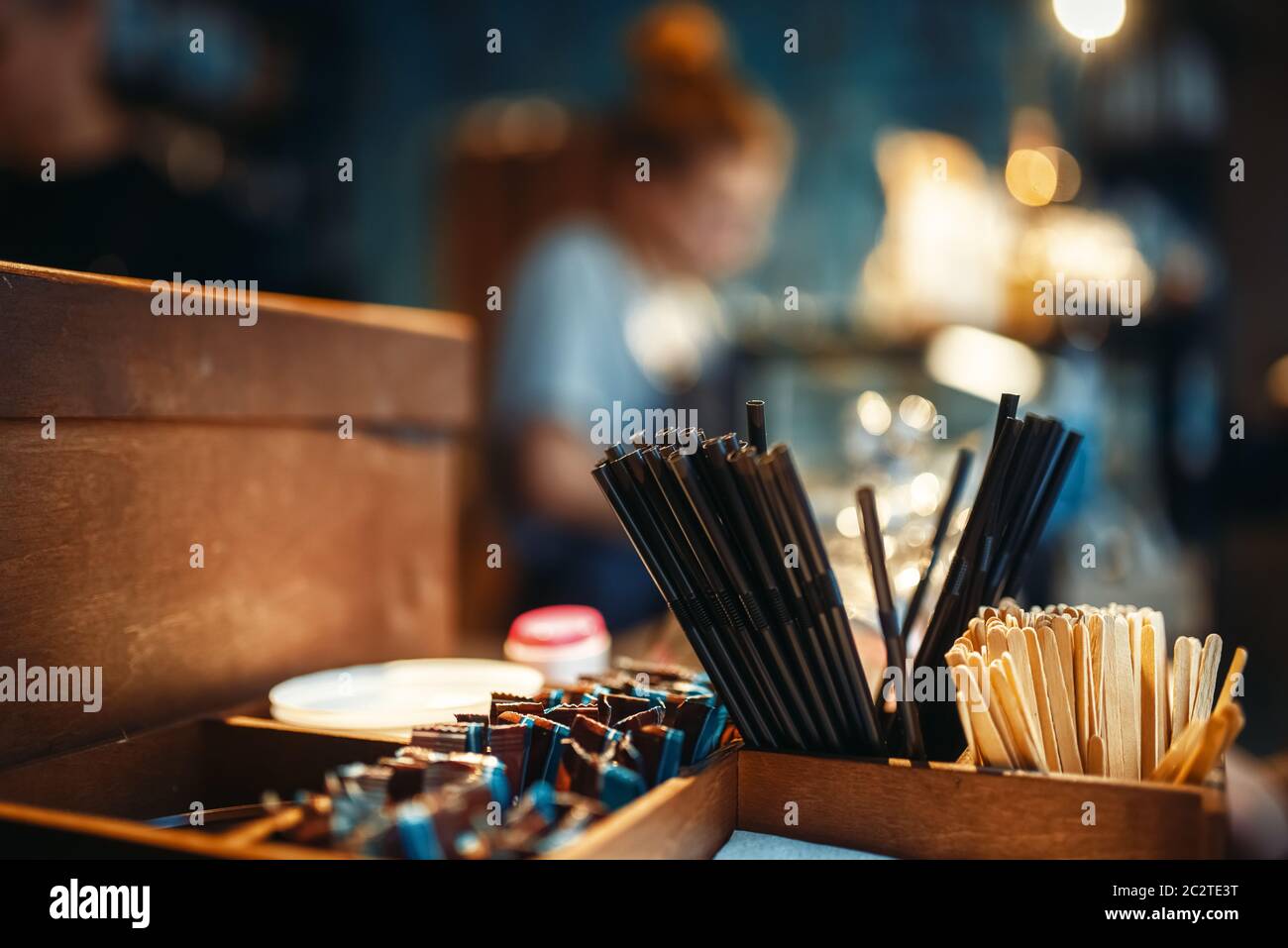Tools for coffee drinking at bar counter closeup. Tubes, wooden sticks ...