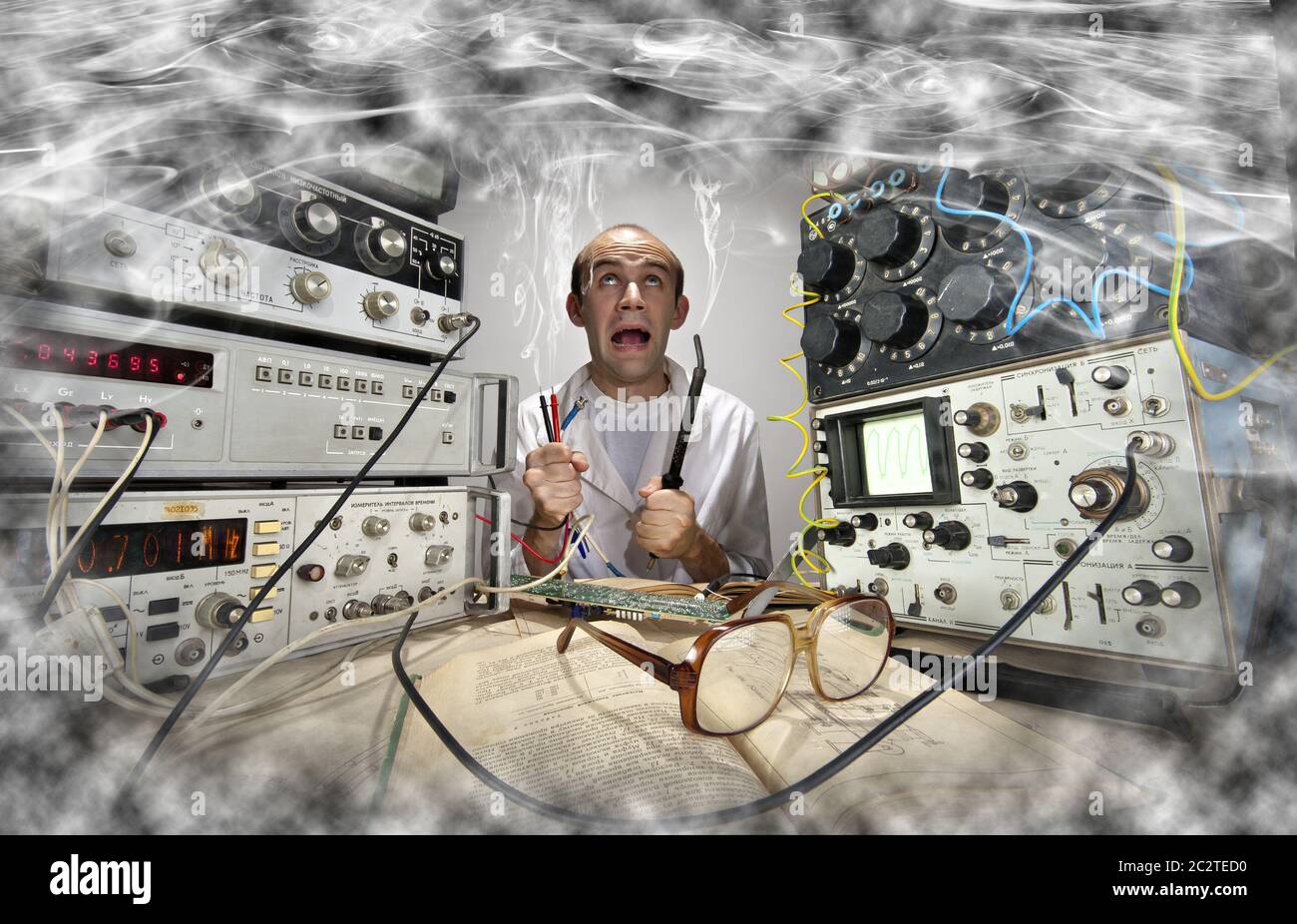 Funny nerd scientist soldering at vintage technological laboratory ...