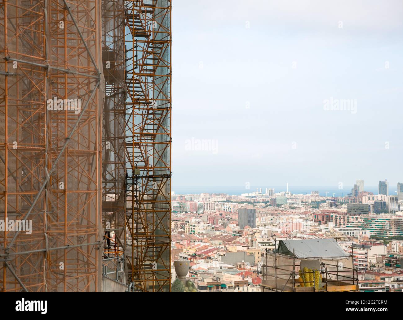 Construction site - scaffolding around new skyscraper against cityscape ...
