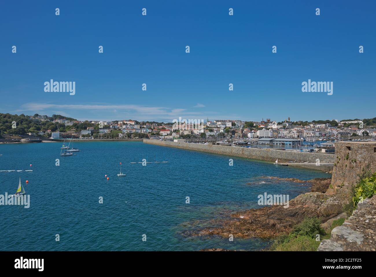 Scenic view of a bay in St. Peter Port in Guernsey, Channel Islands, UK ...