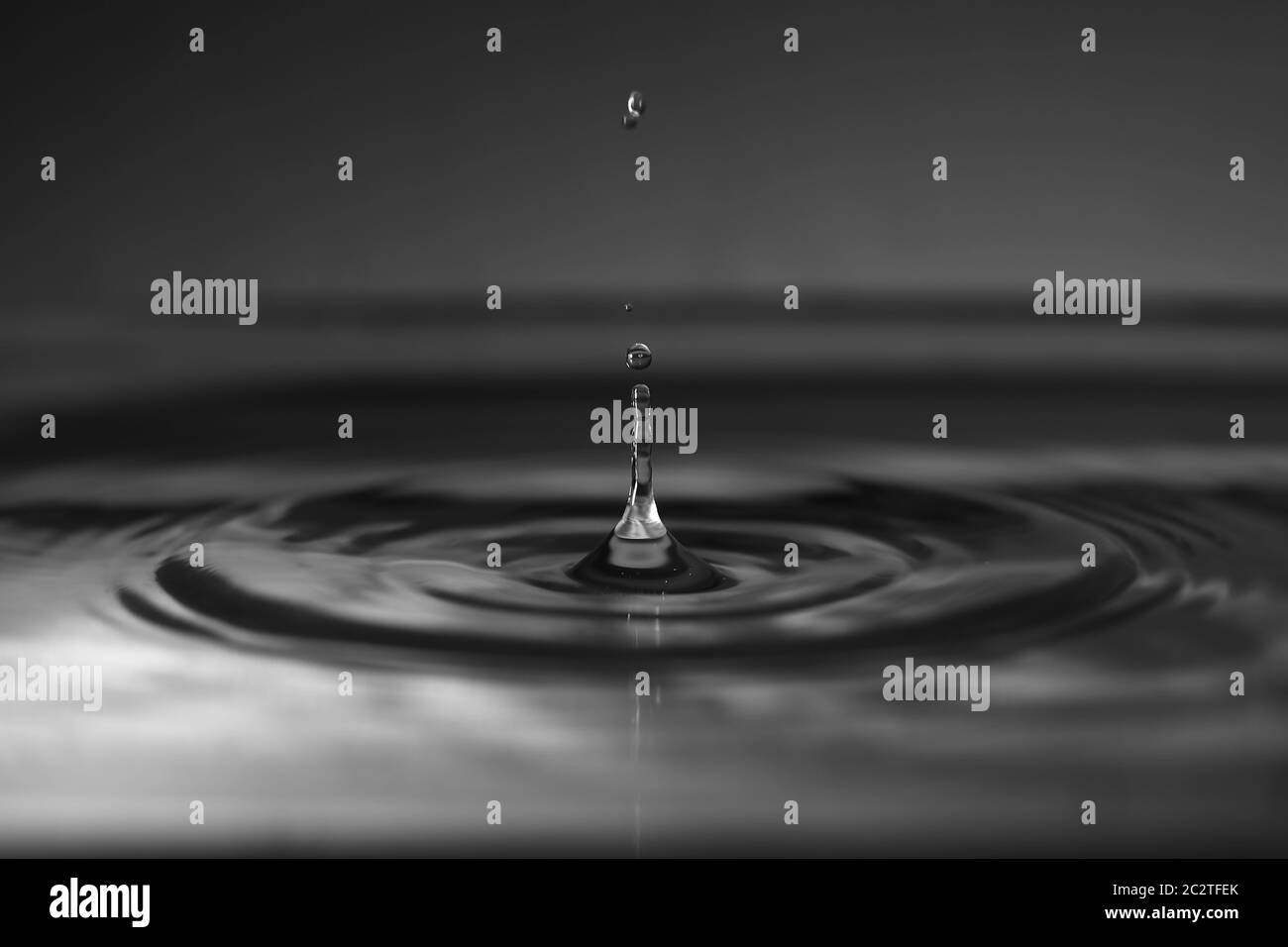 A small water drop fall on water surface Stock Photo - Alamy