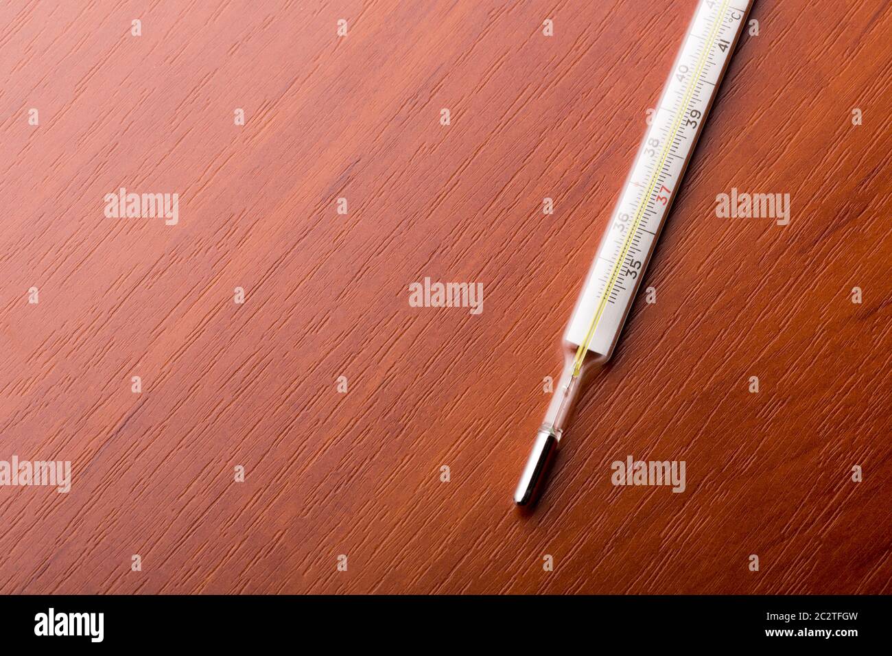 Thermometer on a wooden table with space Stock Photo - Alamy