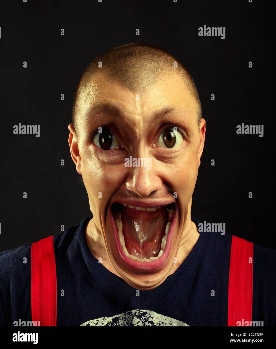 Portrait of very surprised screaming man with giant eyes and open mouth ...