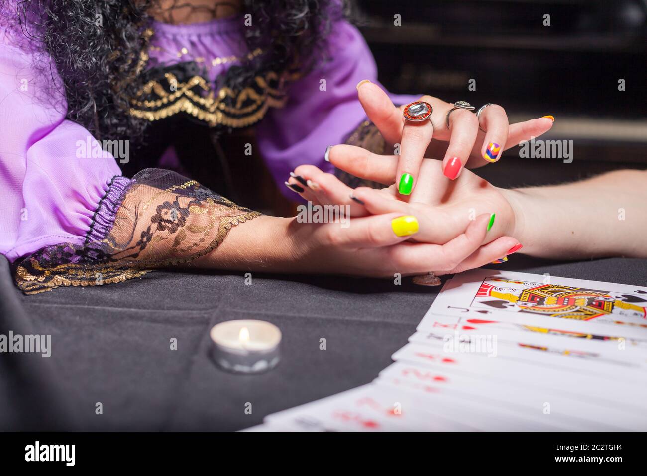 Close up of sorceress reading somebody's hand Stock Photo - Alamy