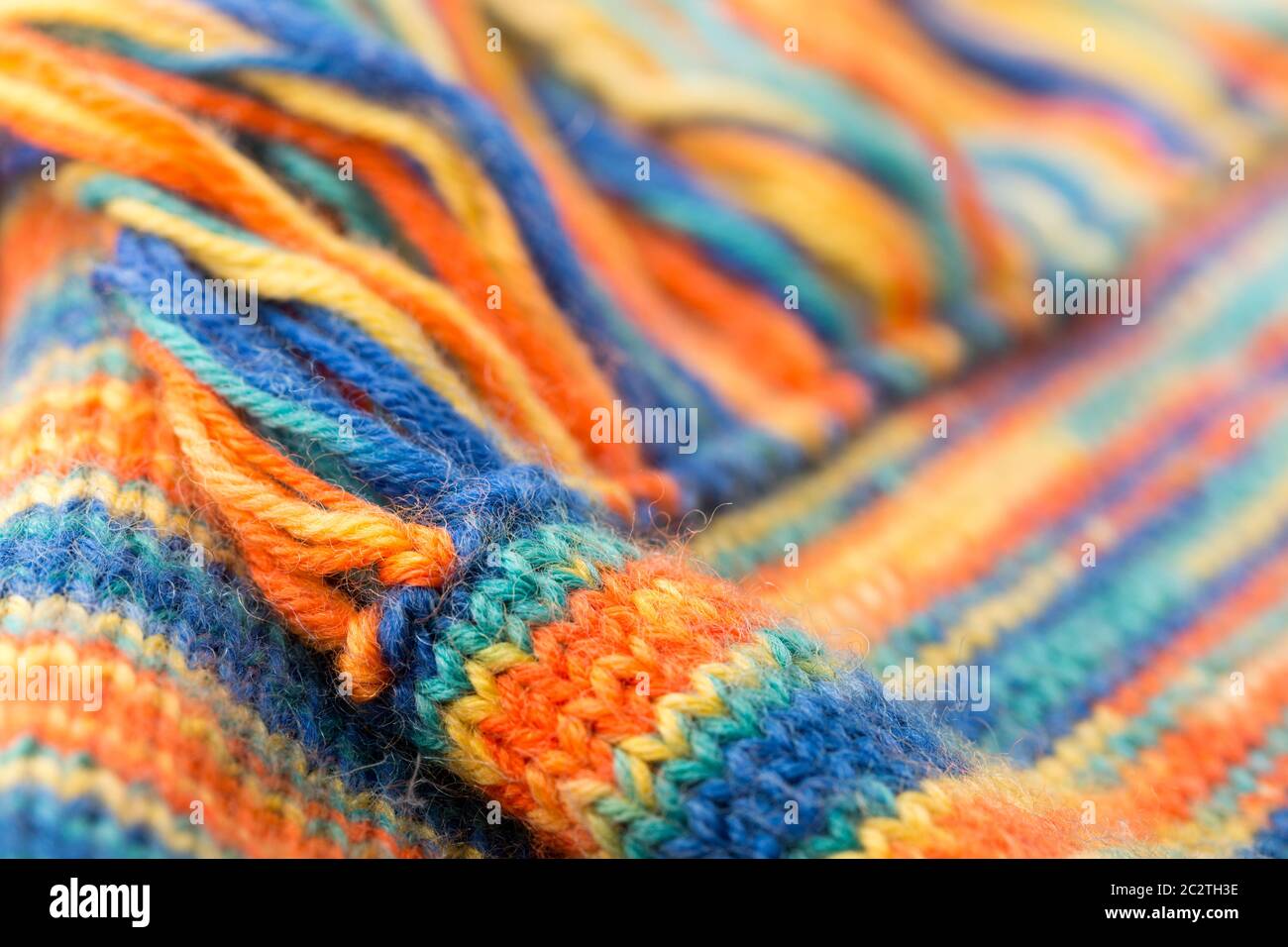 Knitted multicolored texture with fringes Stock Photo - Alamy
