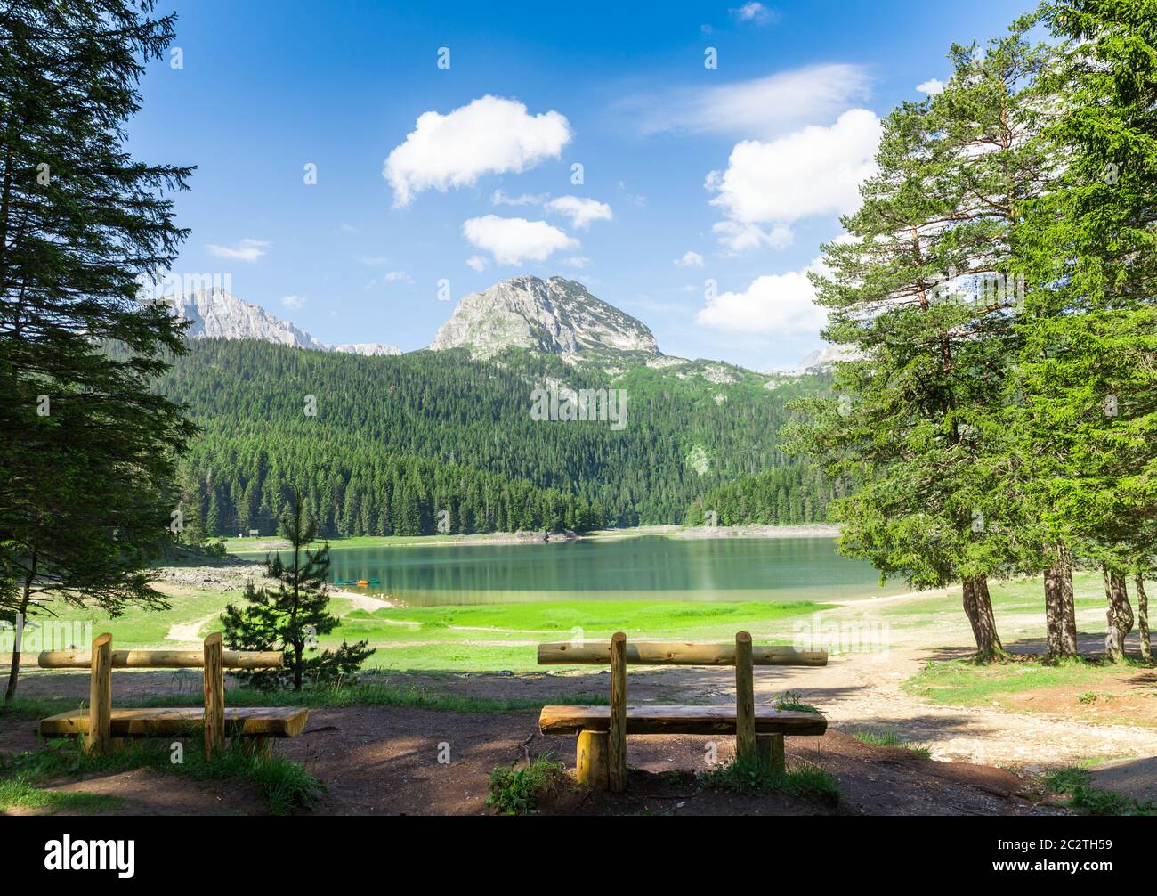 Nice view of mountain lake and wooden benches Stock Photo - Alamy