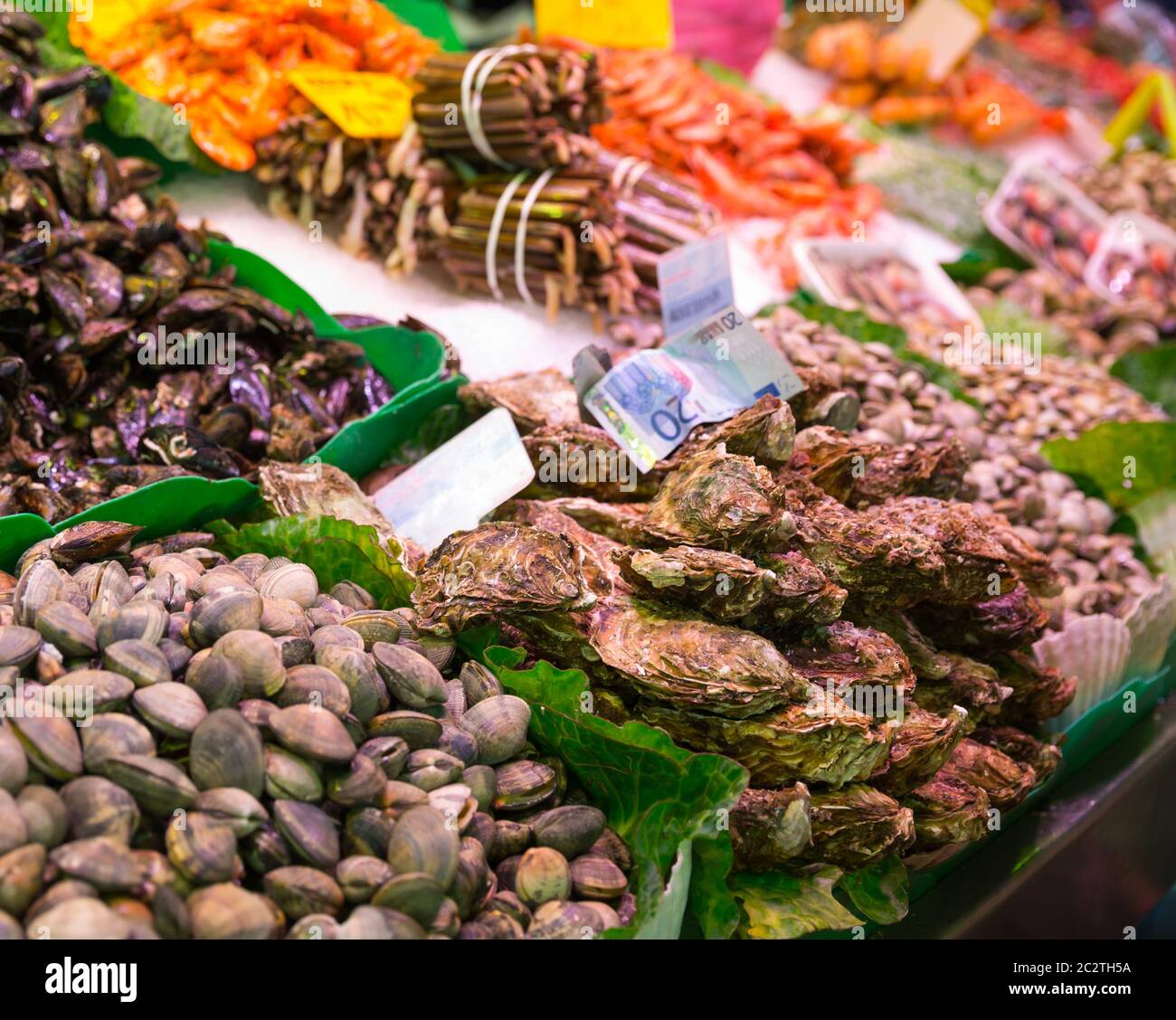 Assorted mollusks on ice in seafood market Stock Photo - Alamy