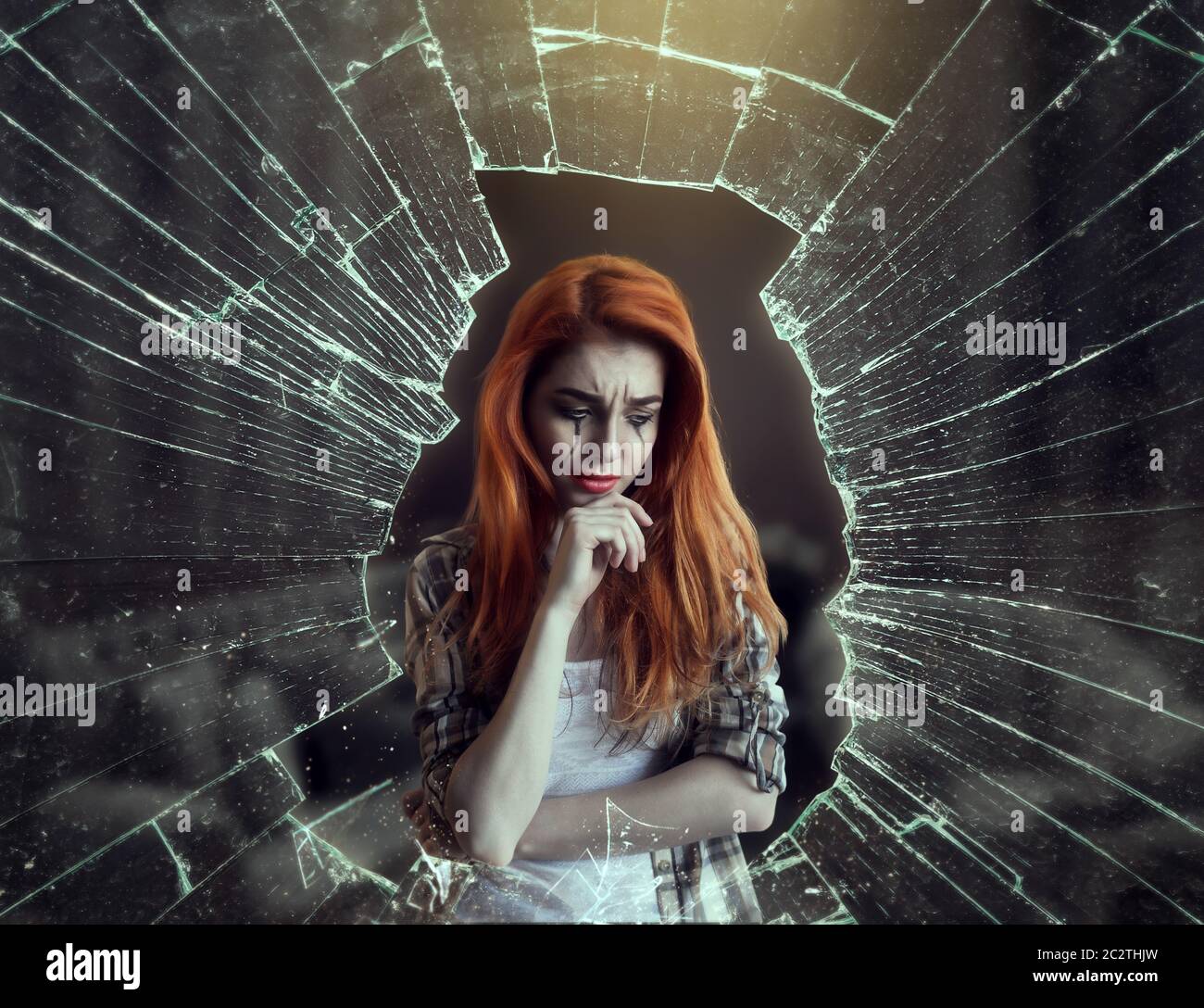 Young woman crying at broken window, family quarrel, conflict. Problem ...