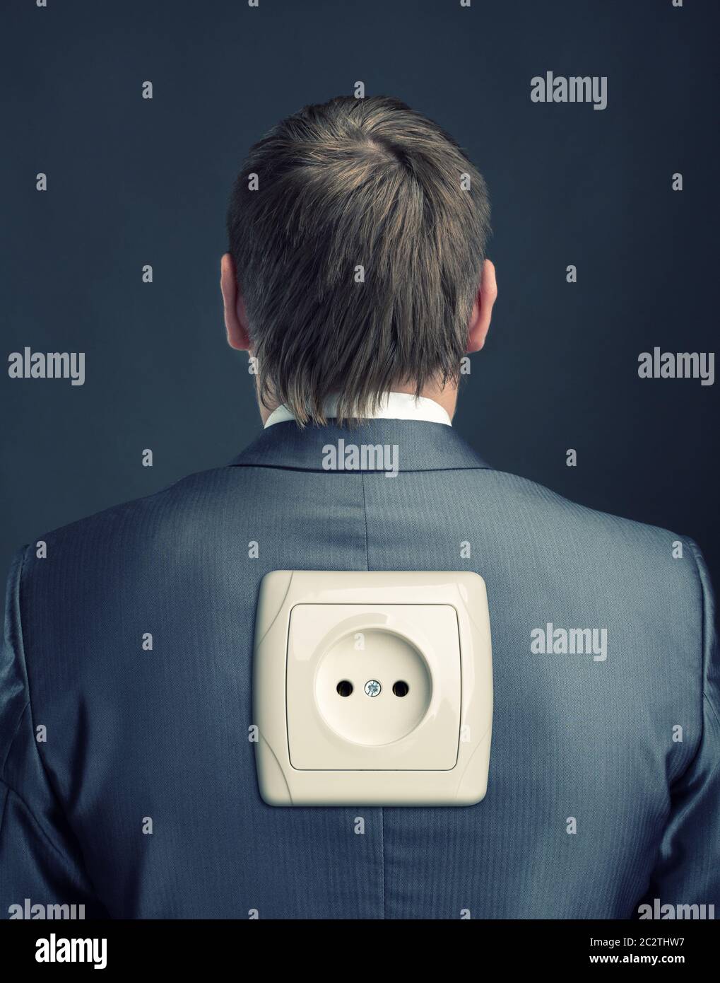 Businessman with electrical outlet on back Stock Photo - Alamy