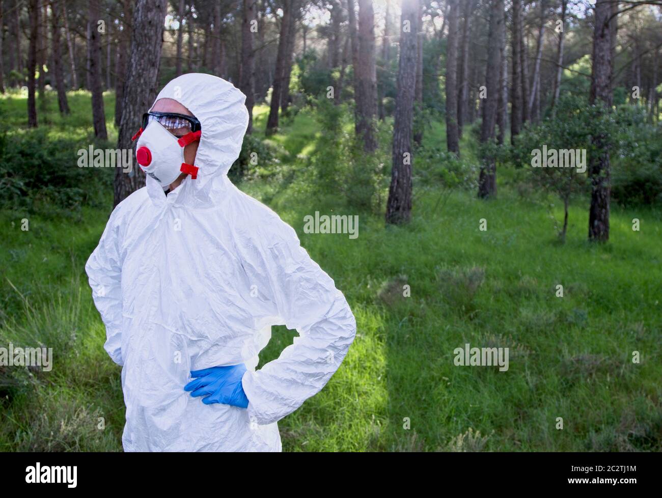 Person with a safety suit in a forest area Stock Photo - Alamy