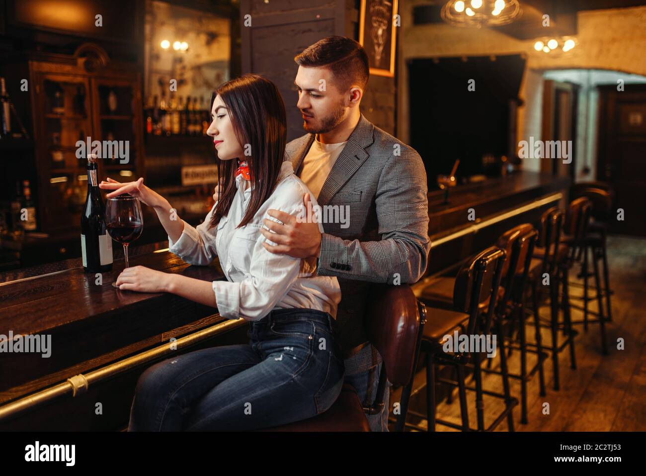 Man and woman relax, couple at wooden bar counter. Lovers leisures in ...