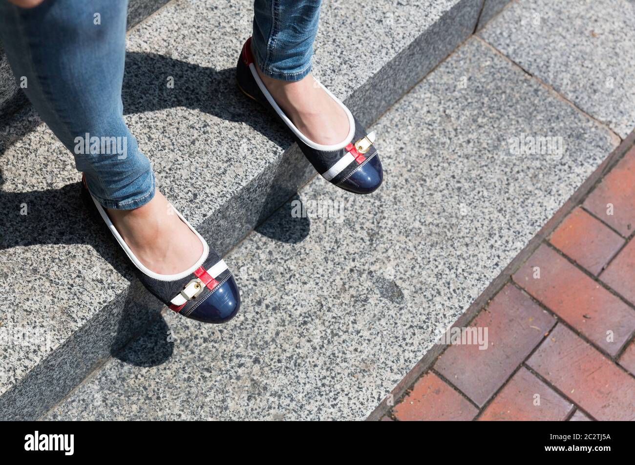 Up view of female feet standing on the stairs Stock Photo - Alamy