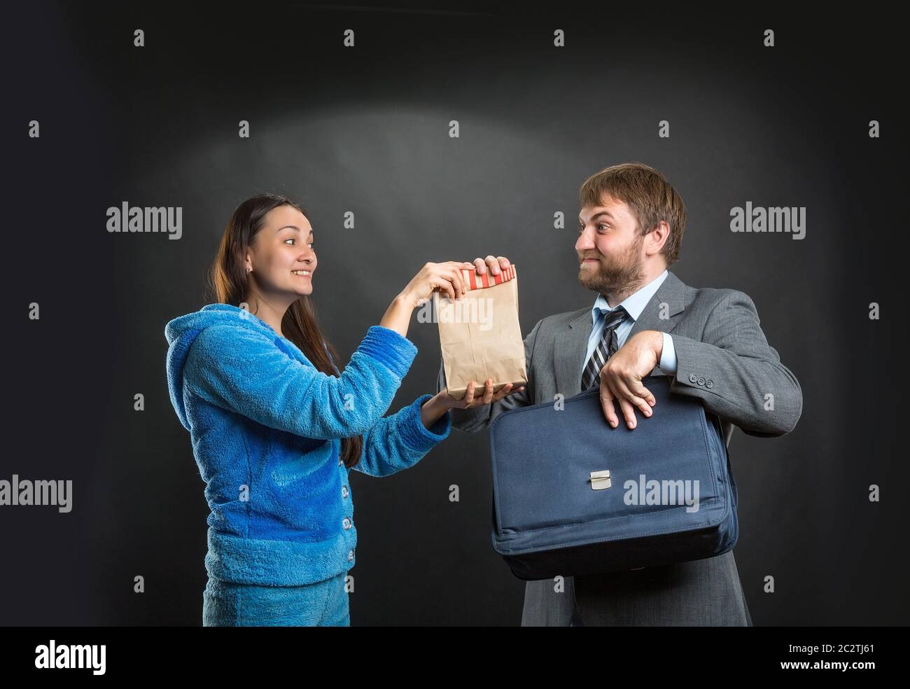 Wife giving snack to her husband Stock Photo - Alamy
