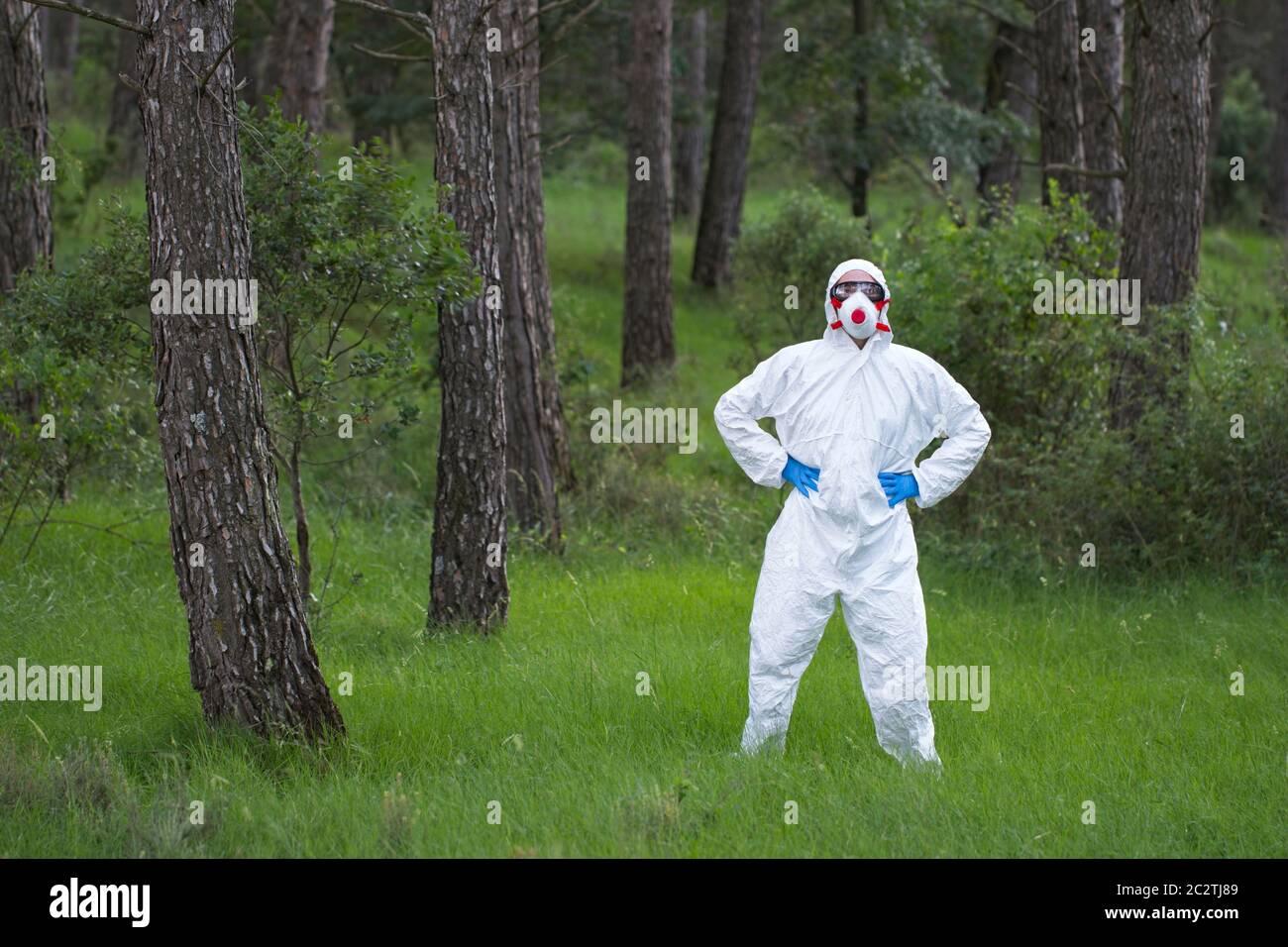 Person with a safety suit in a forest area Stock Photo - Alamy