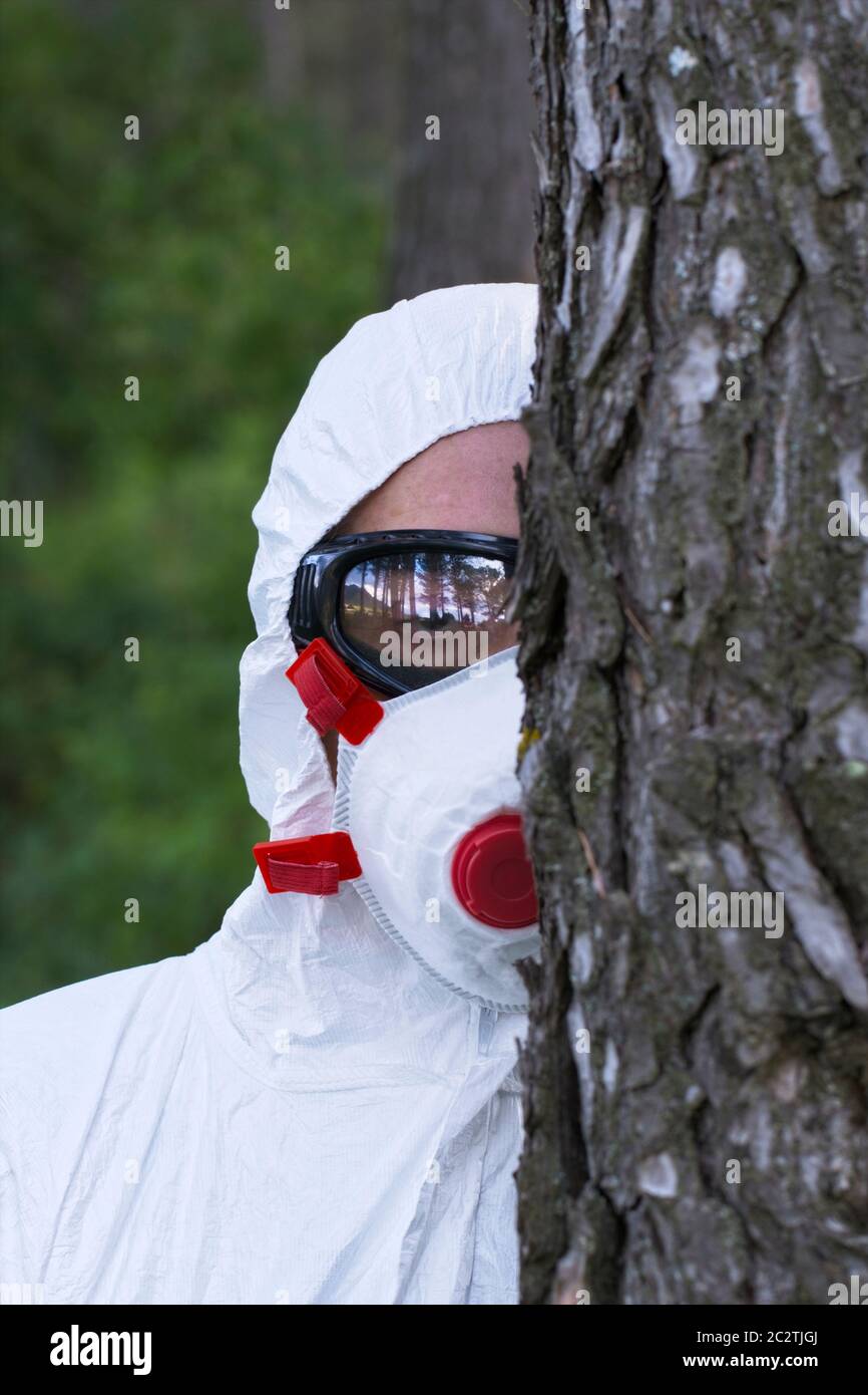 Person with a safety suit in a forest area Stock Photo - Alamy