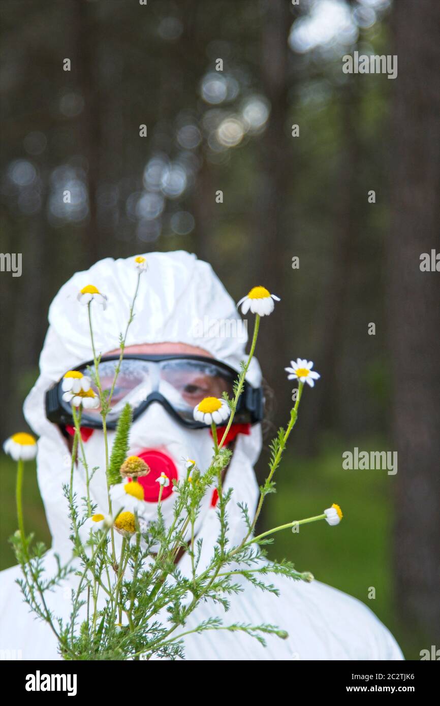 Person with a safety suit and a bunch of flowers in a forest area Stock ...