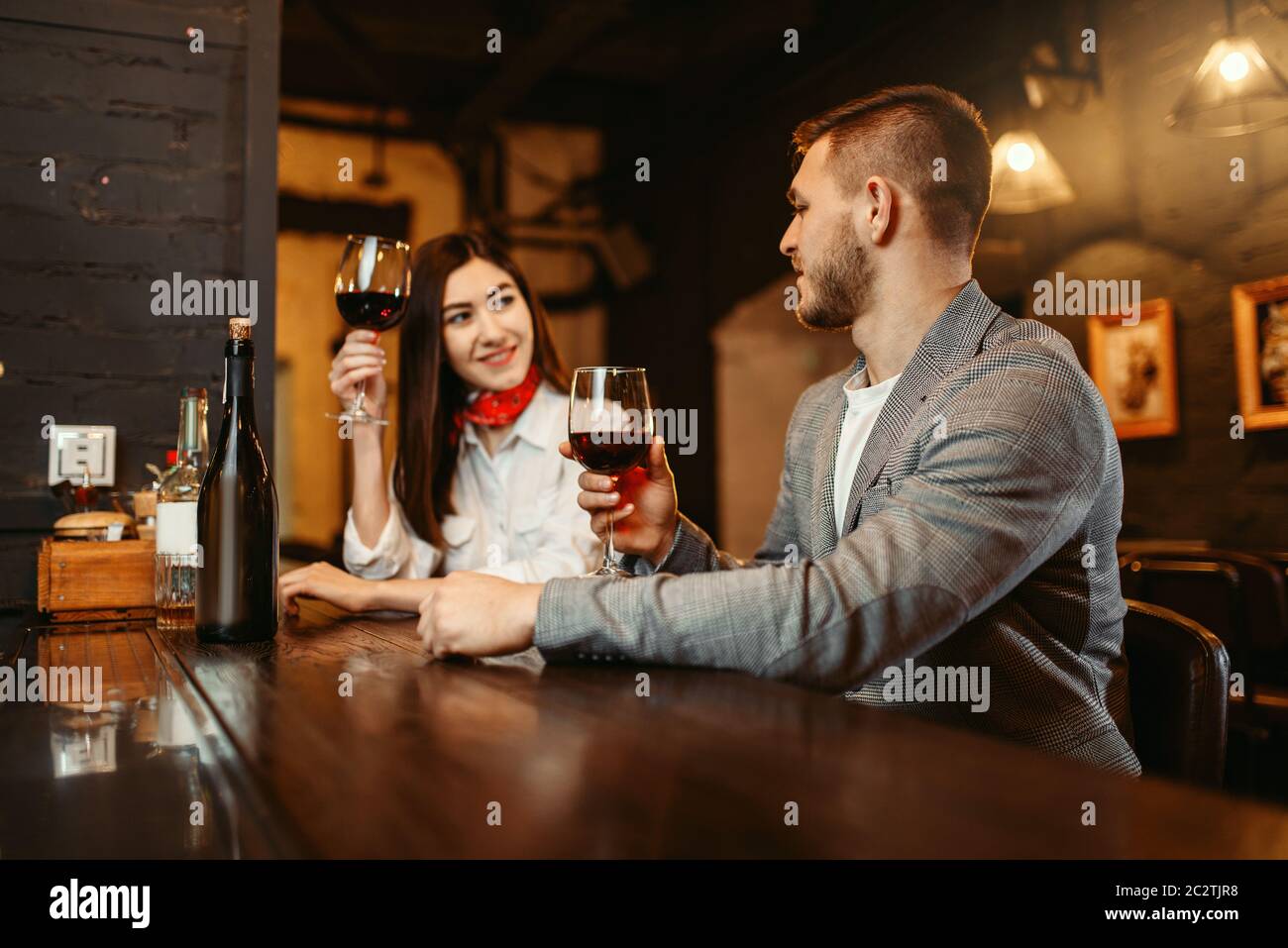 Man and woman flirting in bar, couple at wooden counter. Lovers ...
