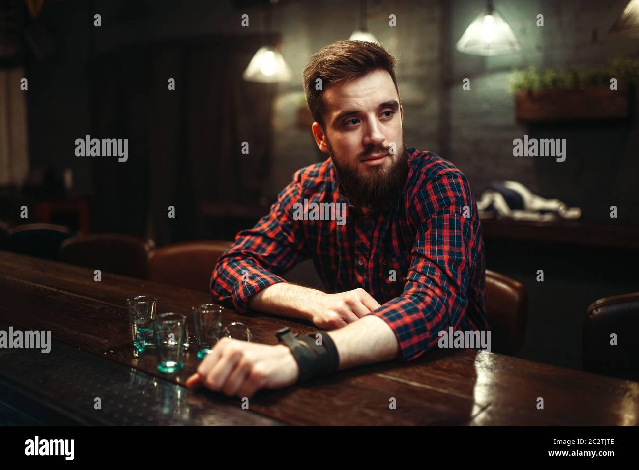 Sad man sitting at the bar counter, alcohol addiction. Male person in ...