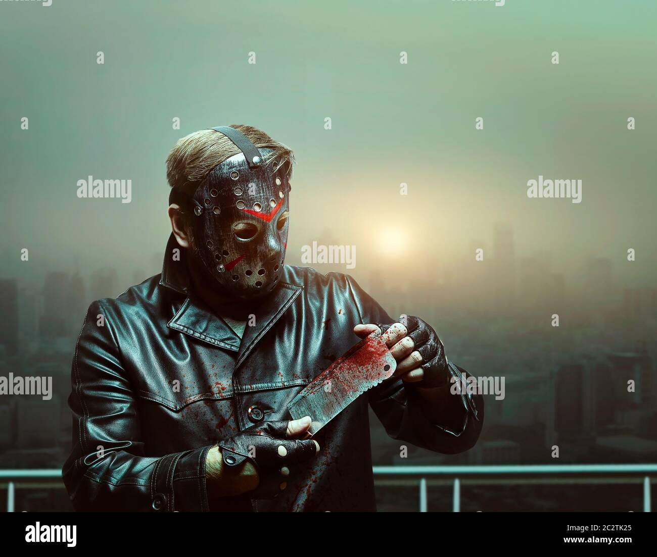 Bloody butcher with meat cleaver after hunting against dark cityscape ...