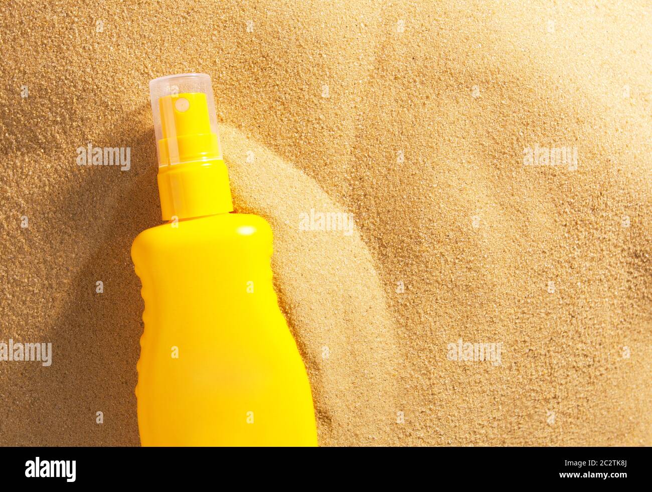 Suntan lotion on the sand Stock Photo - Alamy