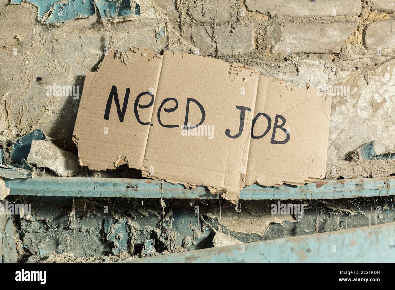Need job. Torn cardboard in old house Stock Photo - Alamy
