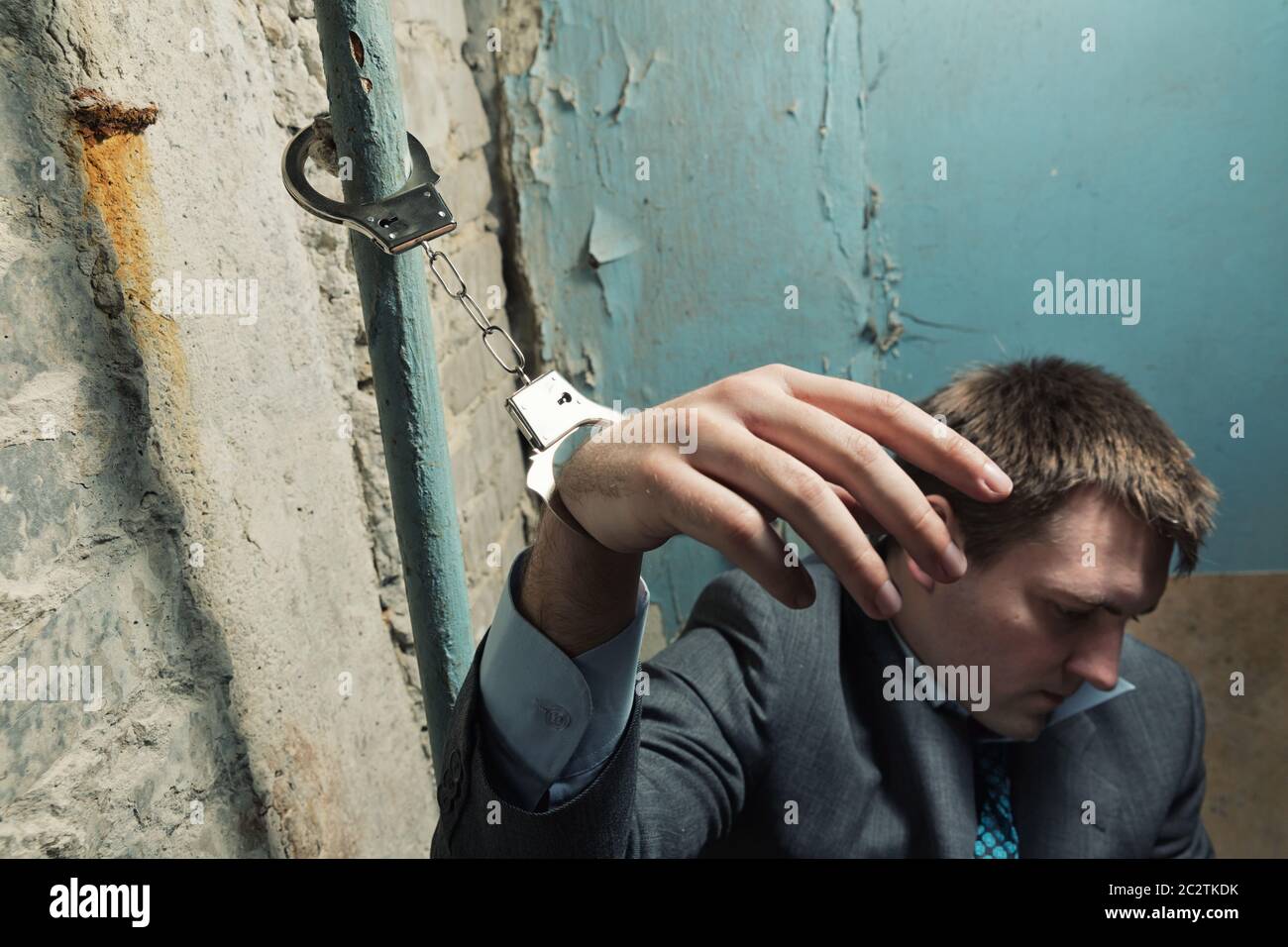 Arrested captive man with handcuffed hand in old house Stock Photo - Alamy