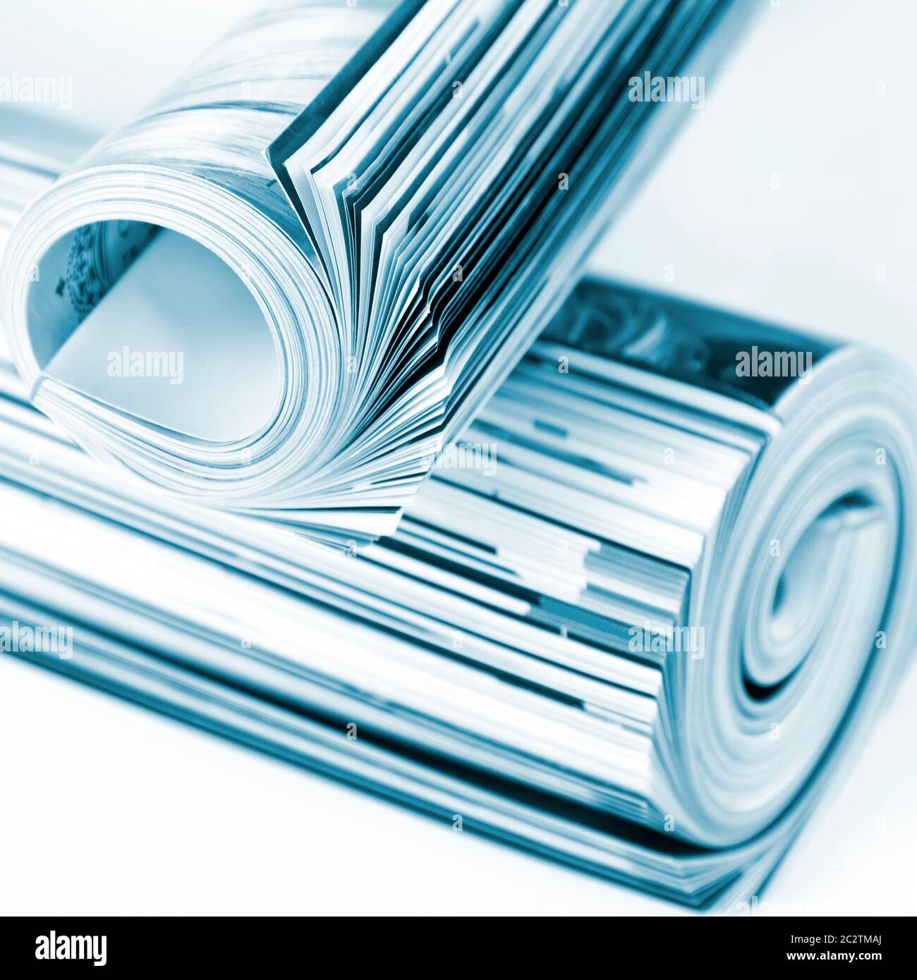 Rolled up magazines. Toned Stock Photo - Alamy
