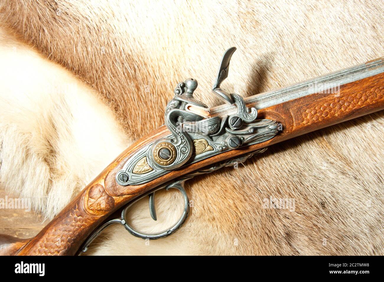 Retro wooden rifle on stuffed animal's skin Stock Photo - Alamy