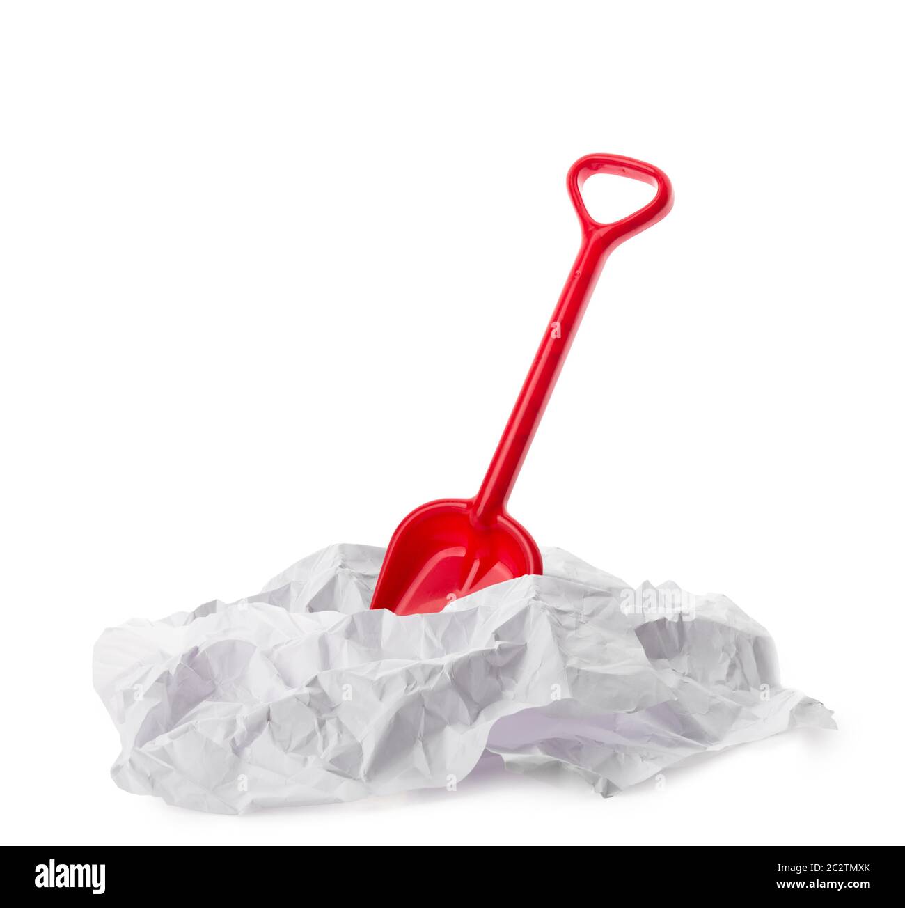Red plastic toy shovel in crumpled paper isolated on a white background ...