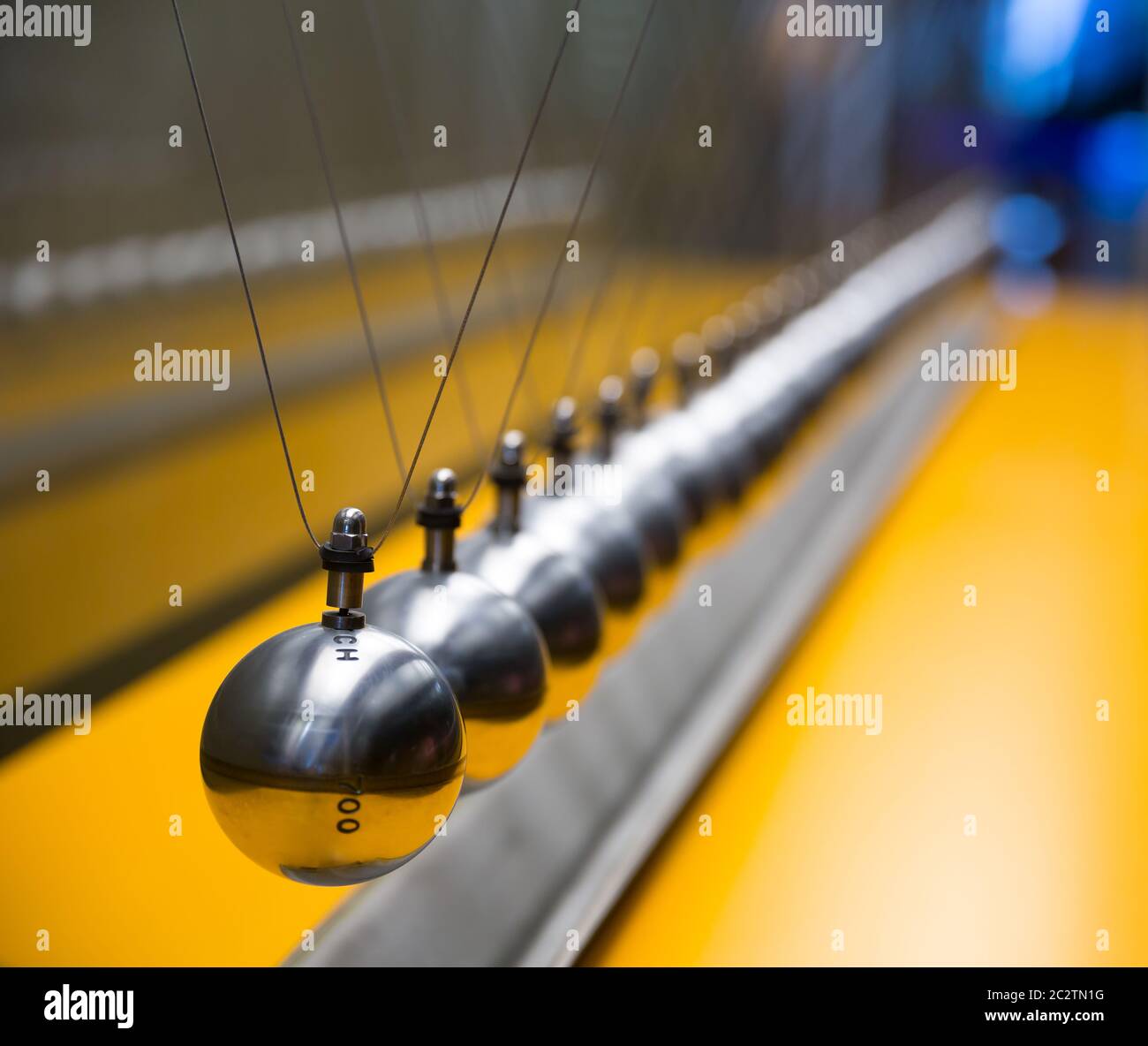 Newton's cradle balancing large group of balls Stock Photo - Alamy