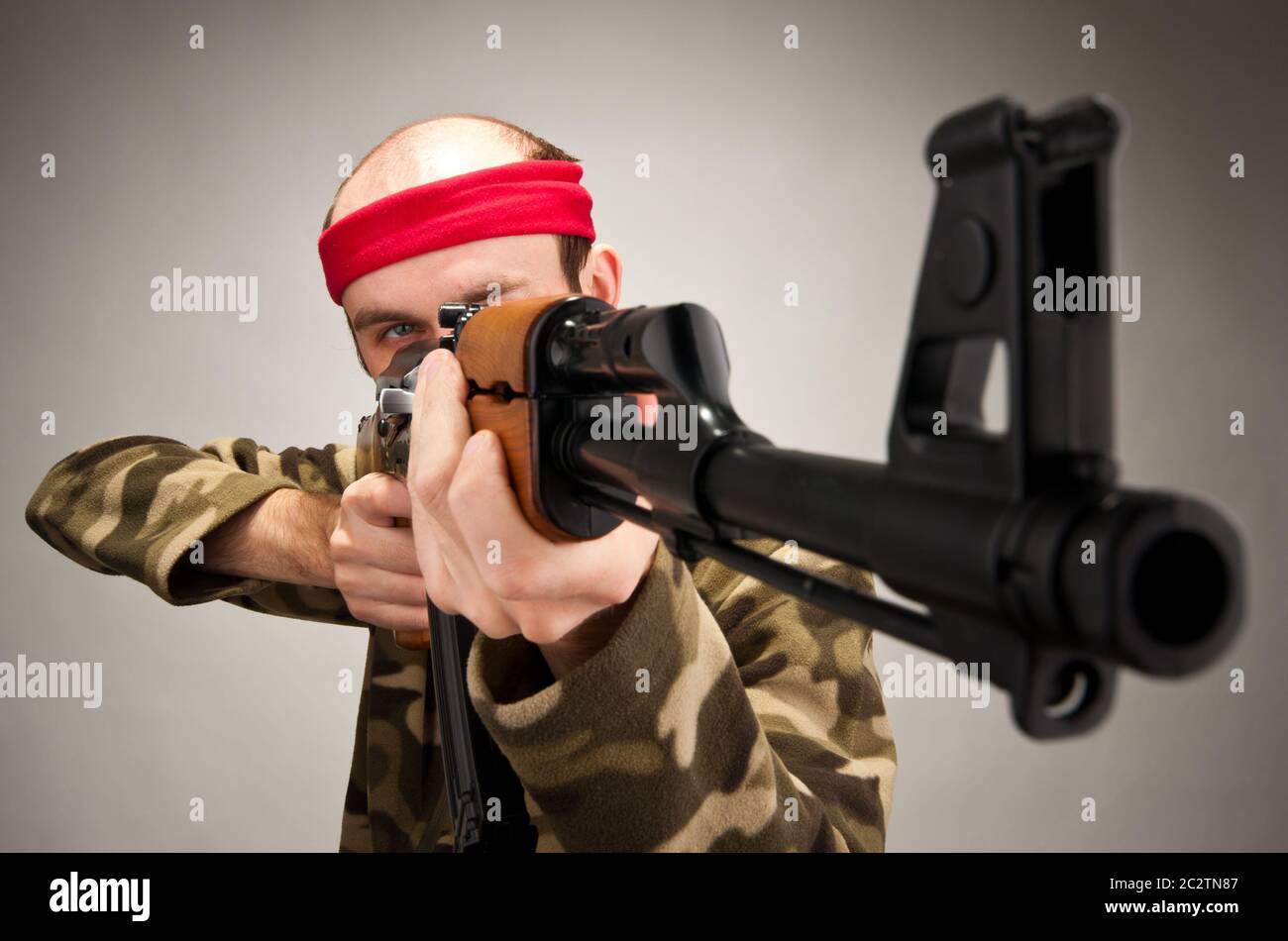 Portrait of funny soldier aiming with machine gun Stock Photo - Alamy