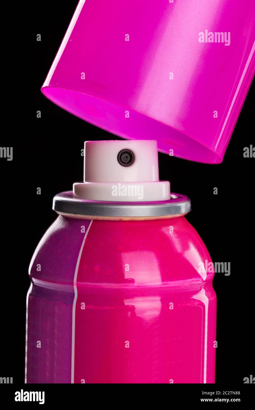 Pink spray aerosol over black closeup Stock Photo - Alamy