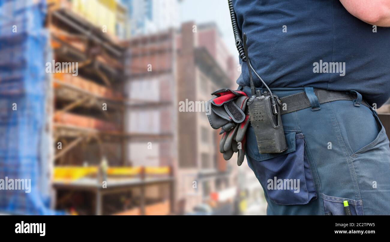 Builder on construction site in old european city. Building engineering ...