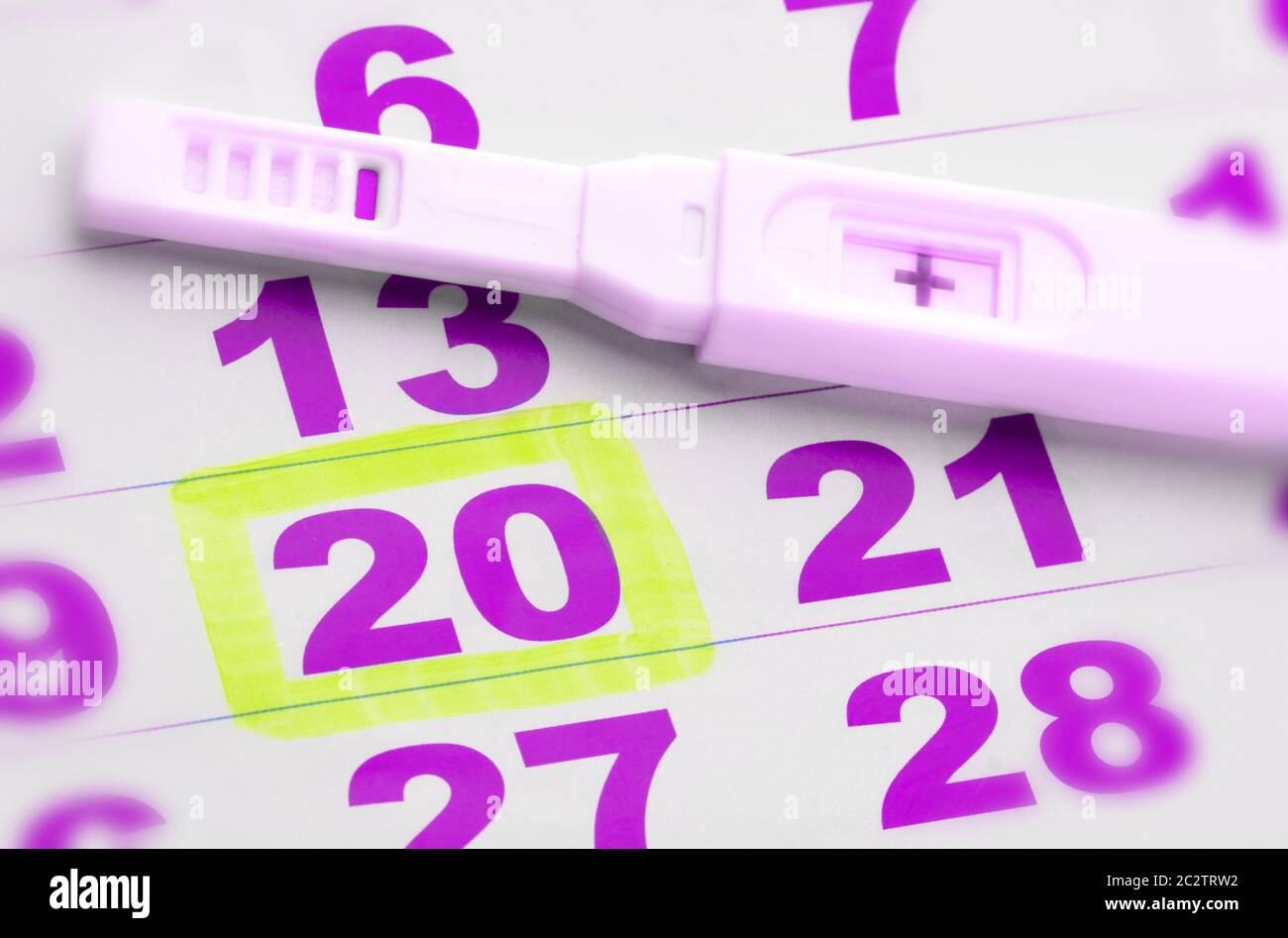 Positive pregnancy test on calendar page Stock Photo - Alamy