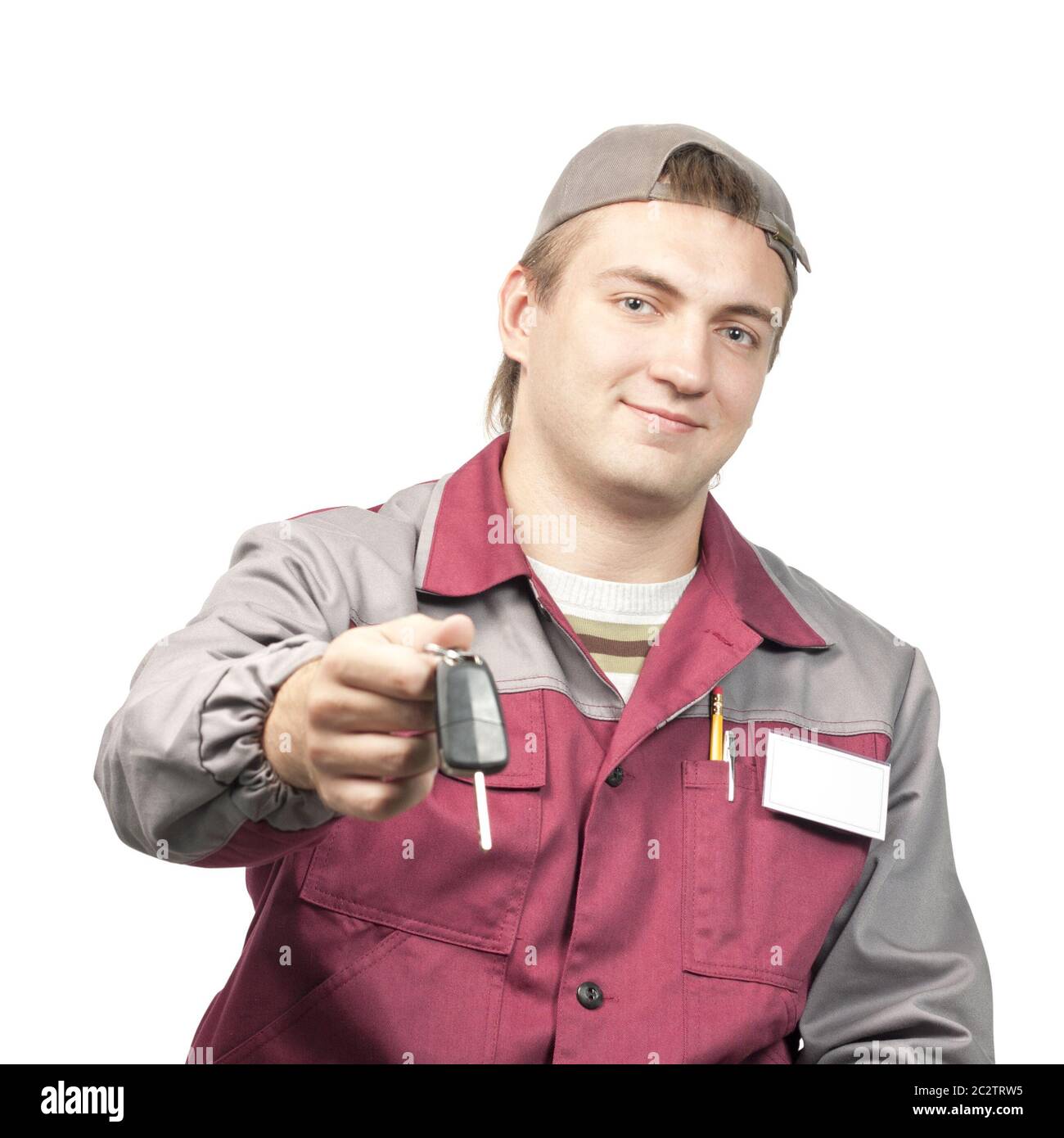Mechanic giving a car key. Isolated on white Stock Photo - Alamy