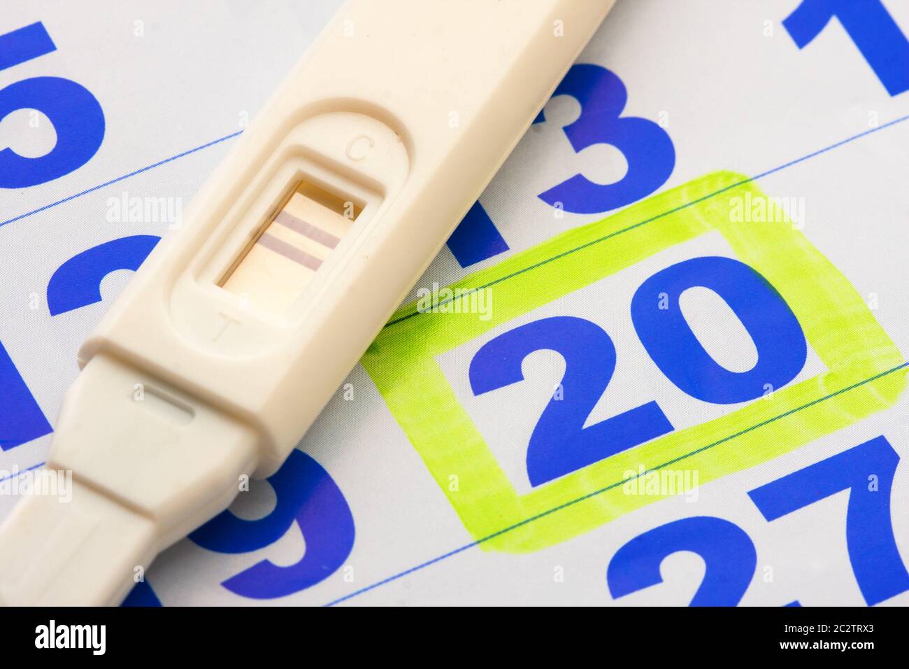 Positive pregnancy test on calendar page Stock Photo - Alamy