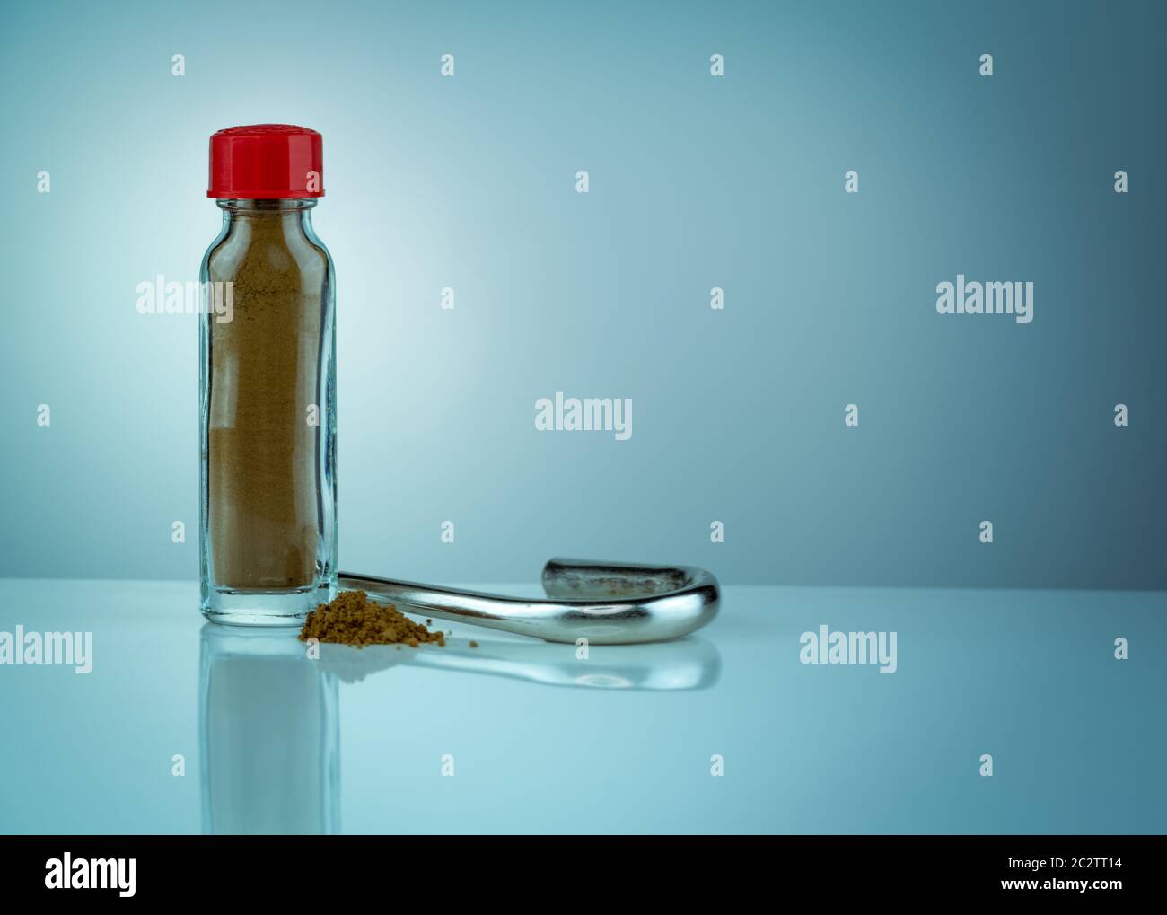 Thai herbal powders snuff in transparent glass bottle with red cap and ...