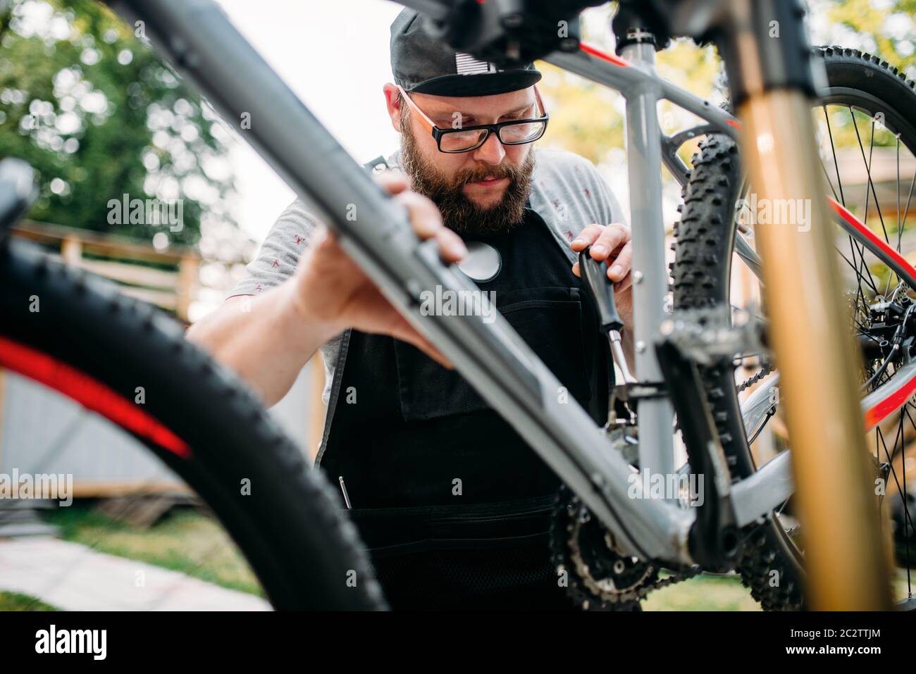 Bicycle mechanic repair bike, cycle workshop outdoor. Serviceman work ...