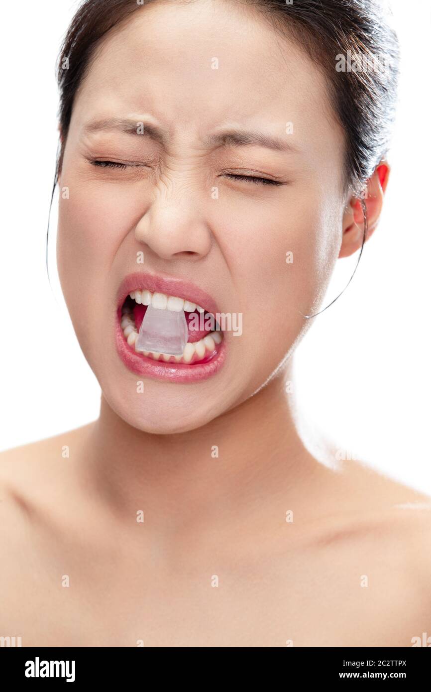 Bite a ice toothache young woman Stock Photo - Alamy