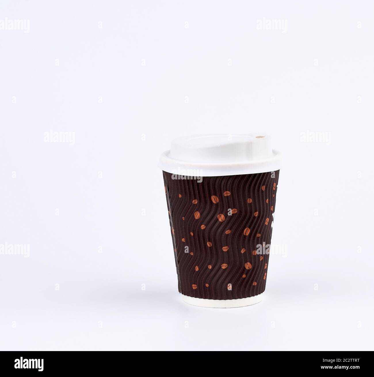 used brown paper cup with plastic cover for hot and cold drinks on a ...