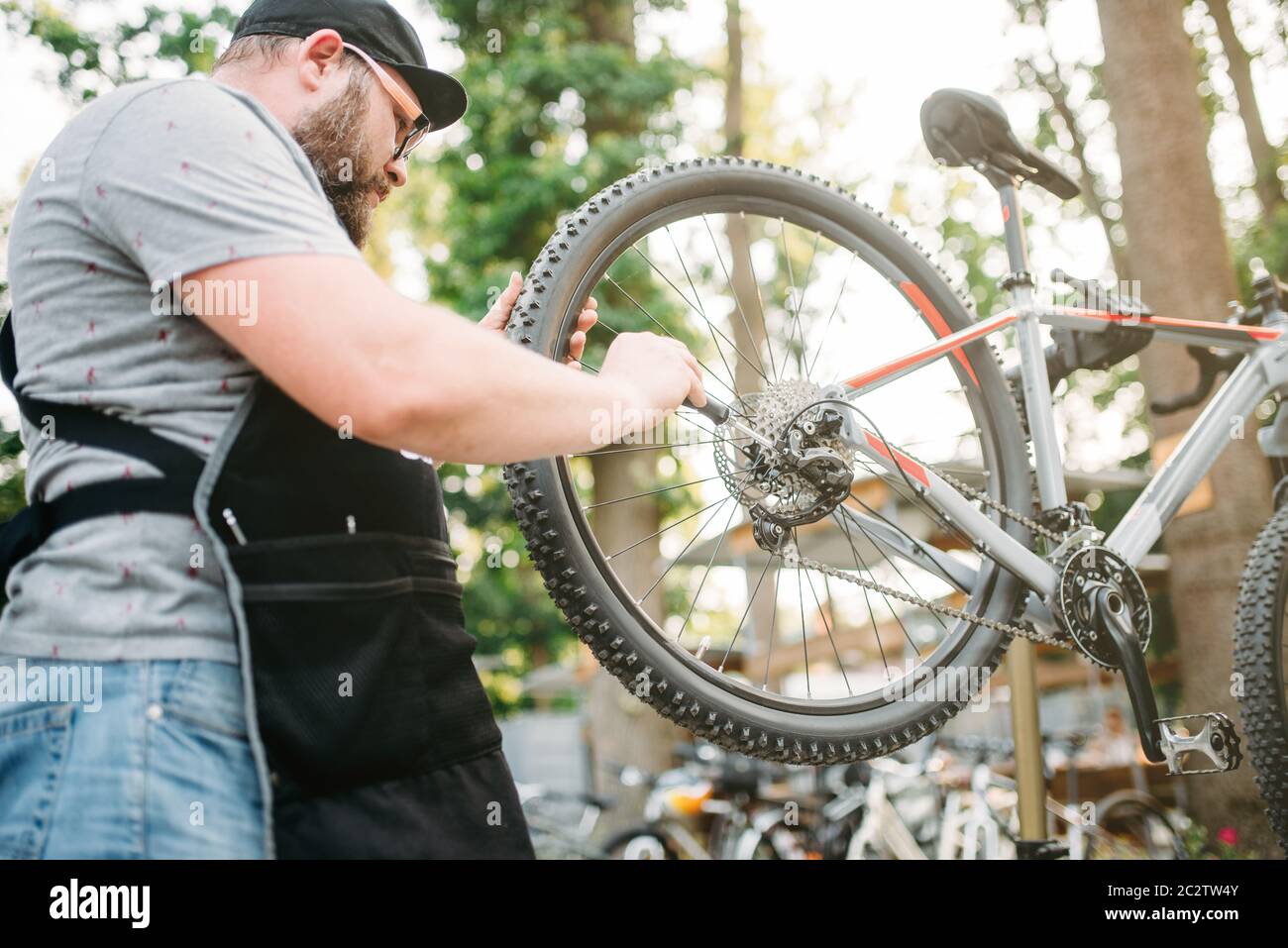 Bicycle mechanic repair bike, cycle workshop outdoor. Serviceman work ...