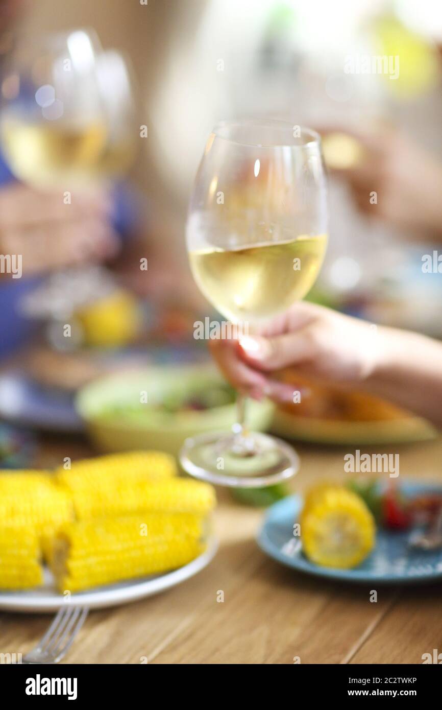 Hands of a group of people cheering with white wine Stock Photo - Alamy