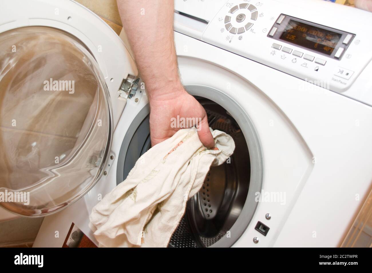Loading the washing machine Stock Photo - Alamy