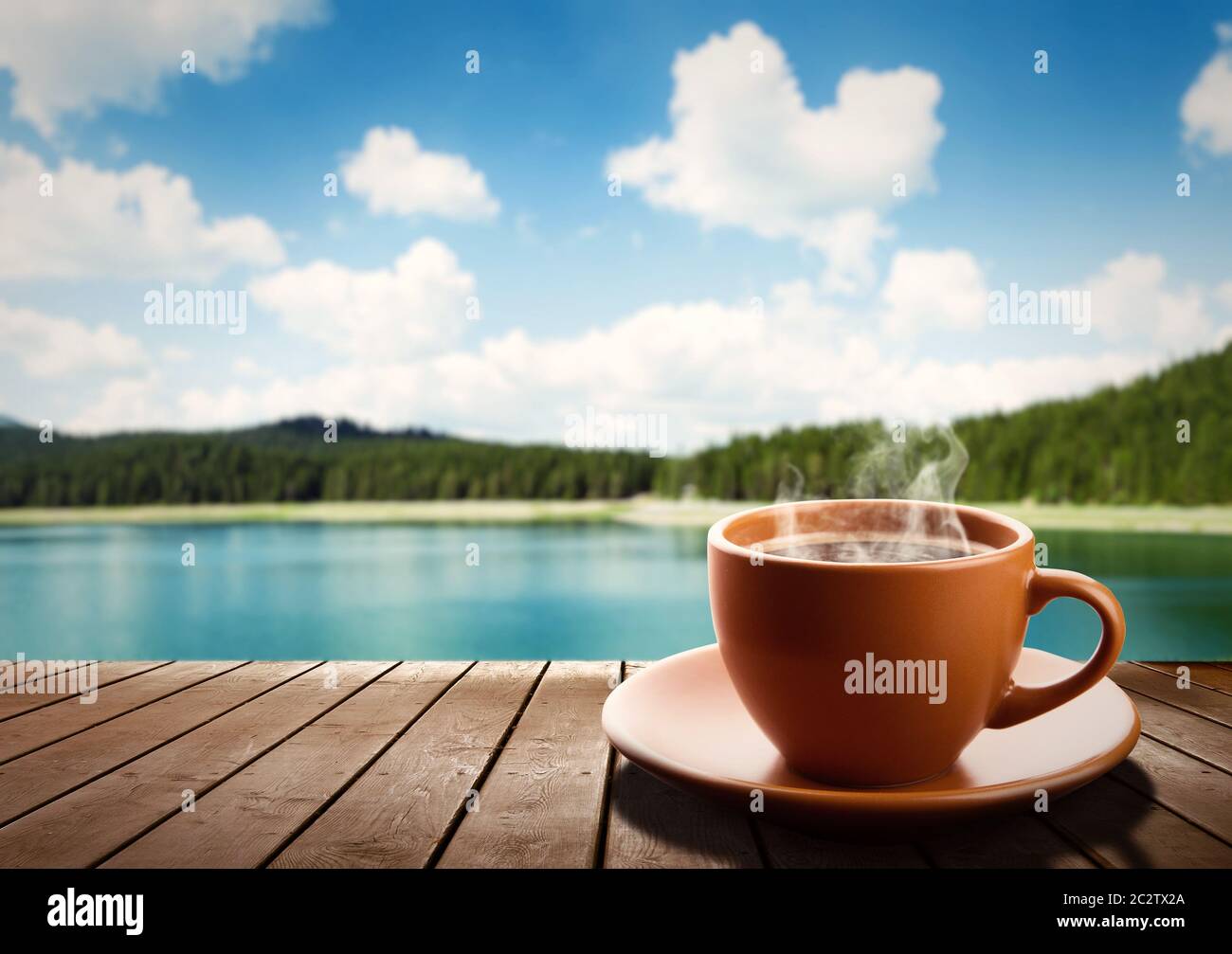 Cup with hot liquid and steam on nature background Stock Photo - Alamy