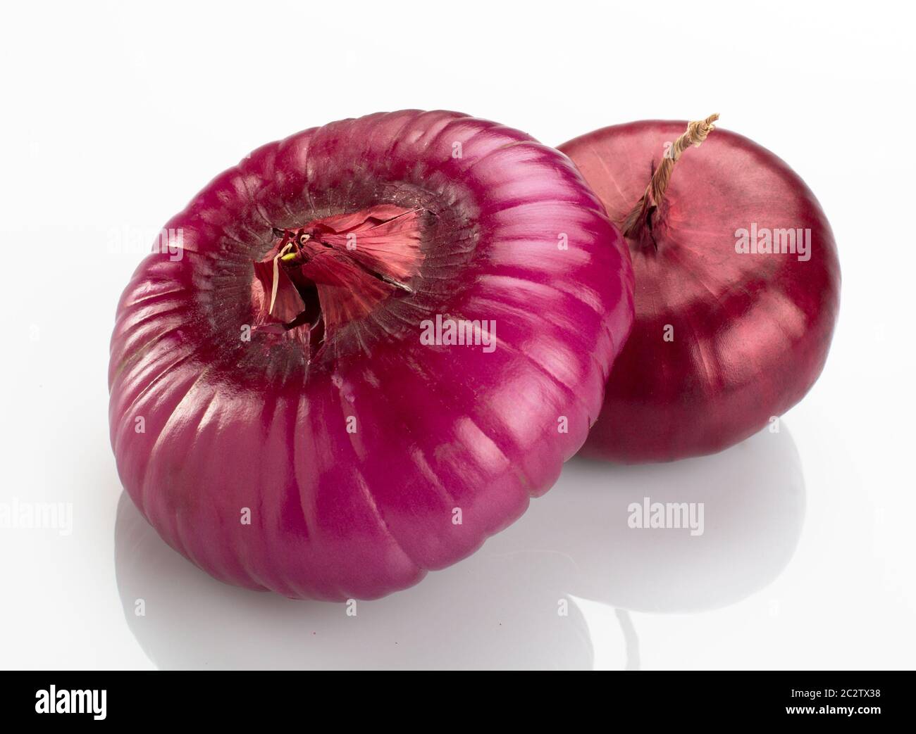 Two red onions on white Stock Photo - Alamy