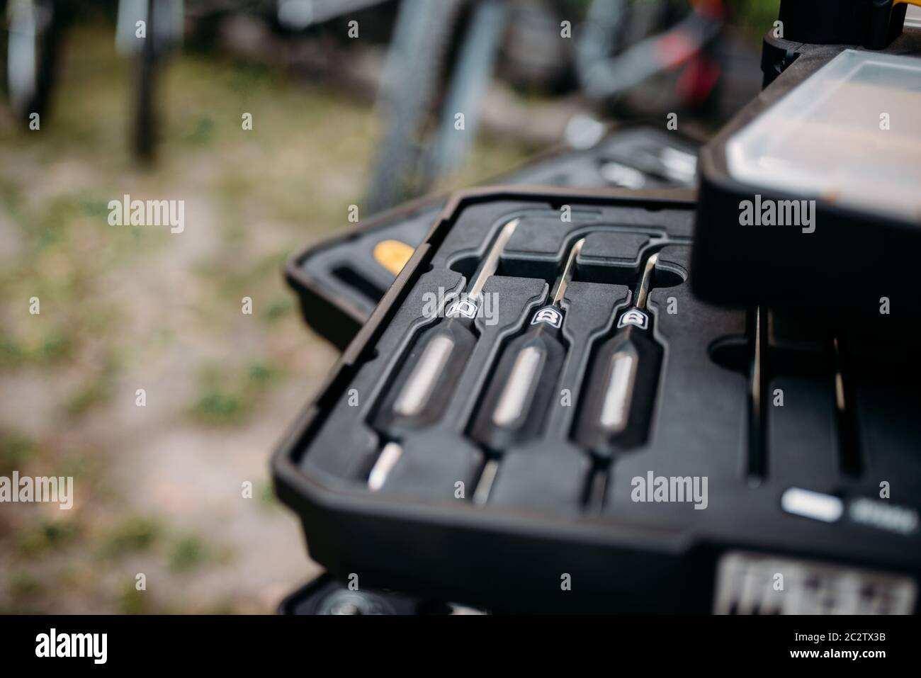 Bicycle tools in box closeup, blur background. Bike equipment in ...