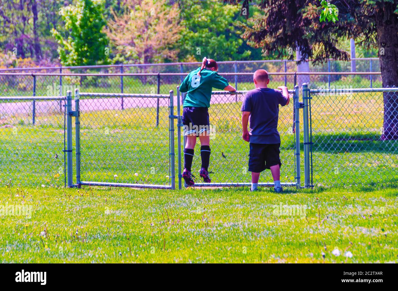 Children playing park fence hi-res stock photography and images - Alamy