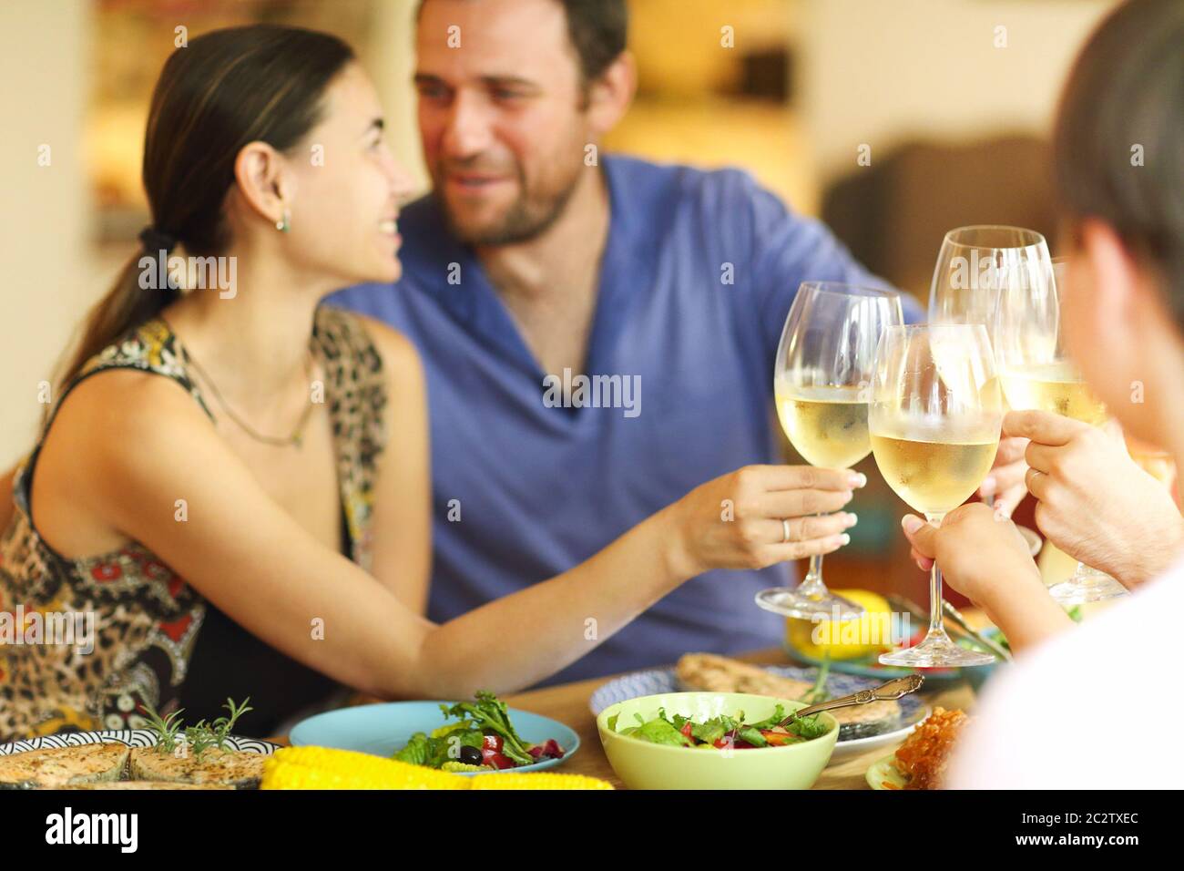 Hands of a group of people cheering with white wine Stock Photo - Alamy