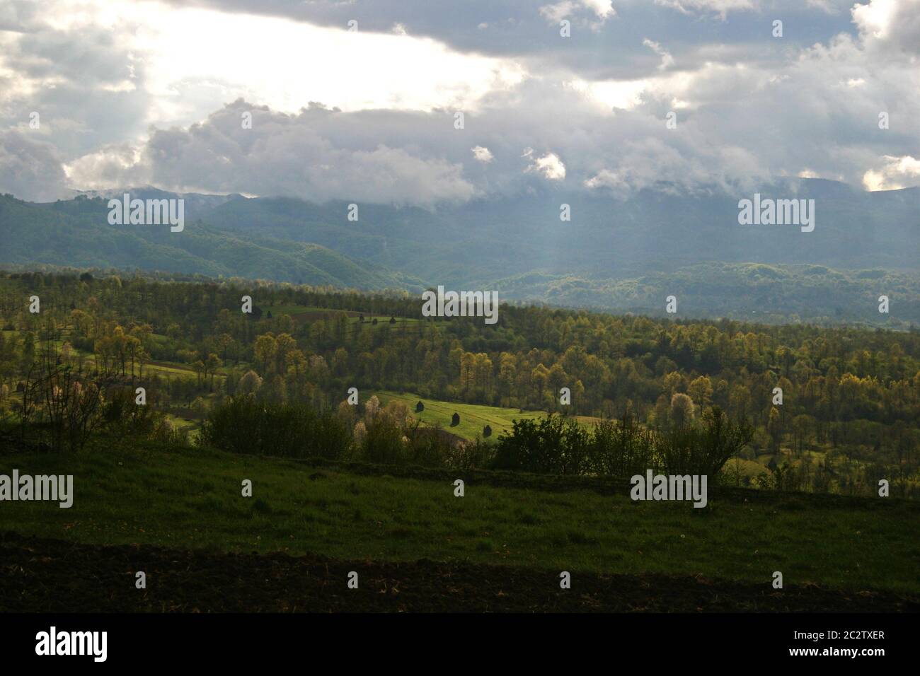 Spring landscape in Maramures, Romania. Sun rays escaping through the ...