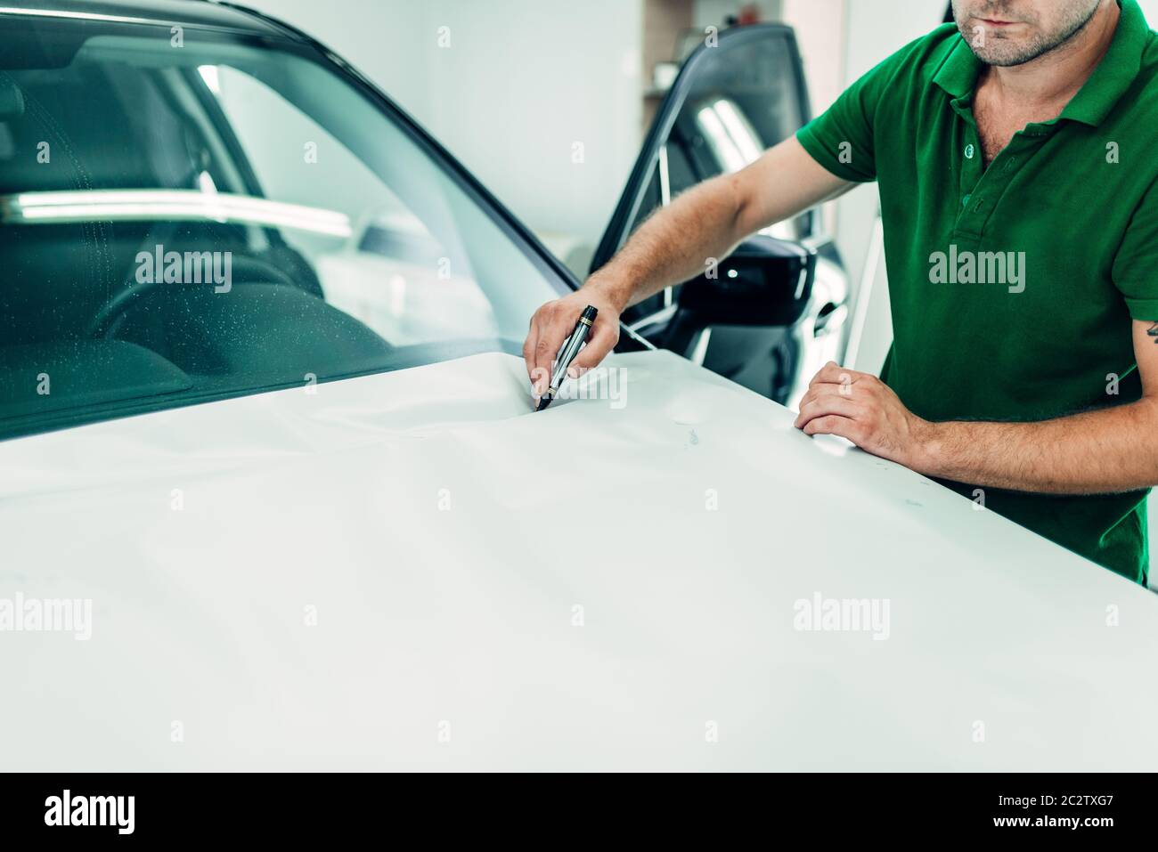 Mechanic prepares car protect coating against chips and scratches ...